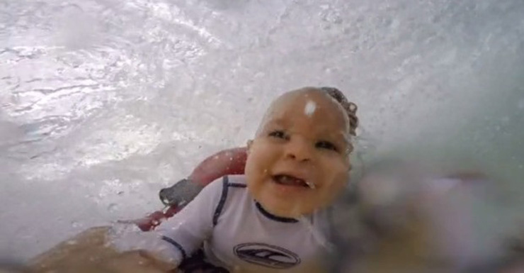 Baby 'totally stoked' to surf his first wave | The New Daily