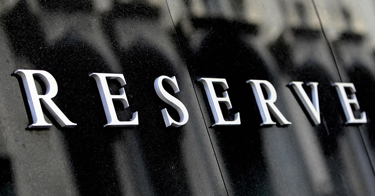 Reserve Bank cuts rates to new record lows after 32 months on hold