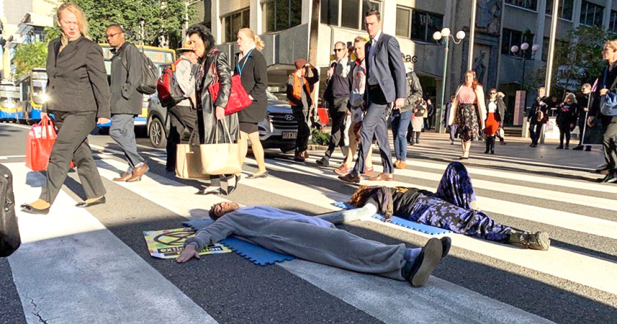 Climate change protesters glue themselves to busy street | The New Daily