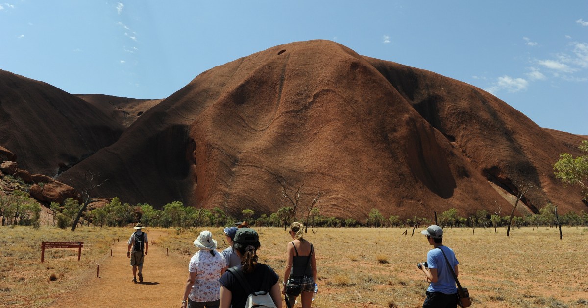 Tourists flock to climb Uluru before ban – bringing 'influx of waste'