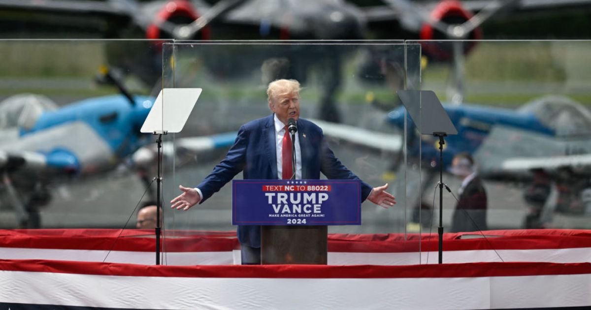 Trump appears behind glass wall at first outdoor rally