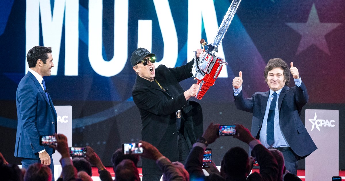 Shouting Musk brandishes chainsaw on stage