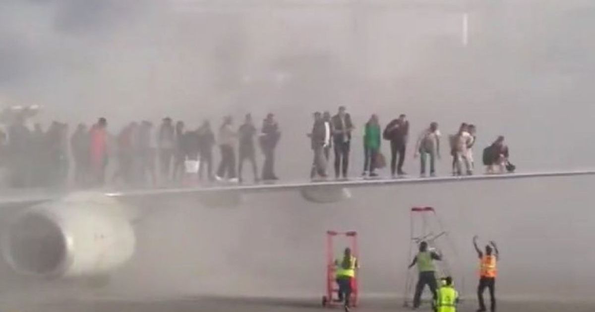 Passengers on wing as plane catches fire